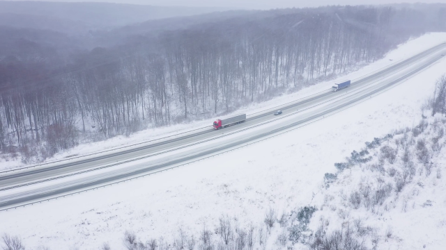 استوک فوتیج جاده برفی 30272 Aerial View Of Traffic On A Road Surrounded By Winter Forest In